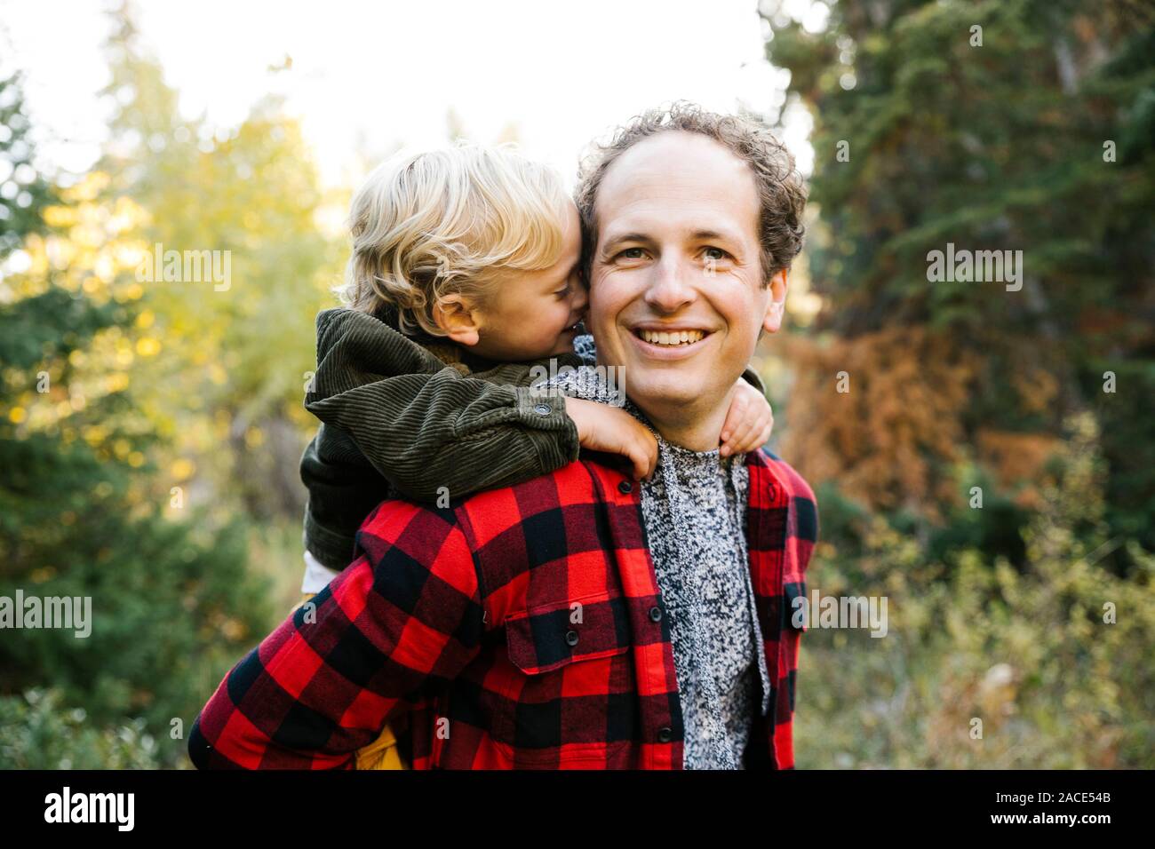 Father and son piggyback in forest Stock Photo - Alamy