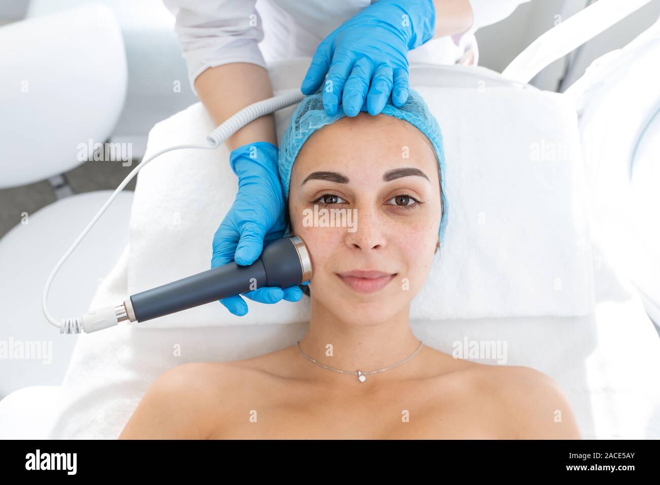 portrait of a young beautiful girl rf face lifting procedure. Face care ...