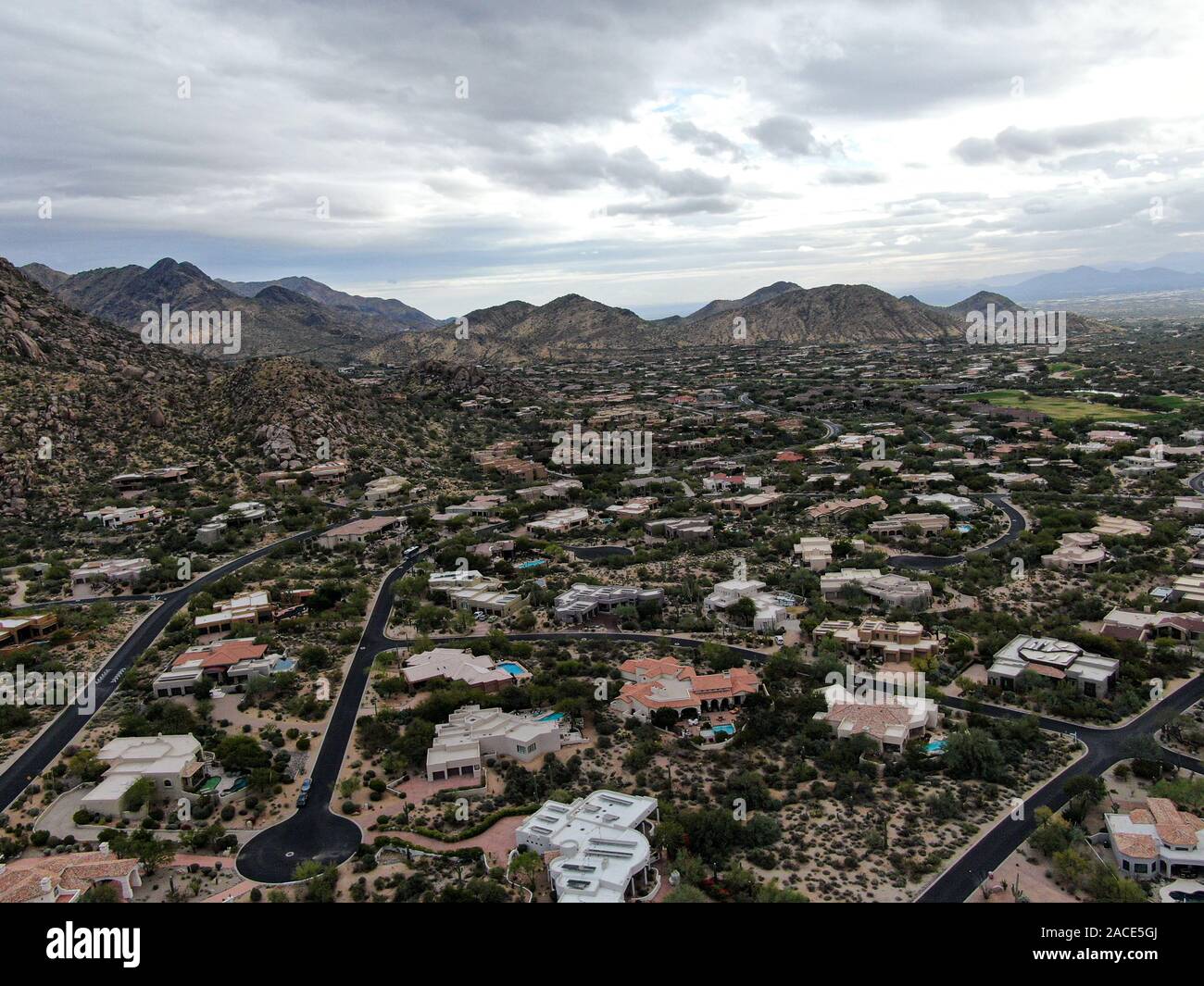 Aerial view of upscale luxury homes with dry landscape mountain and ...