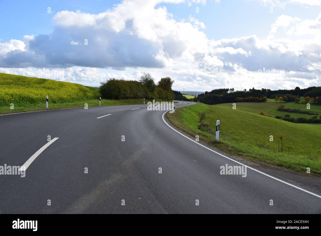 curvy country road curve in rural Eifel Stock Photo - Alamy