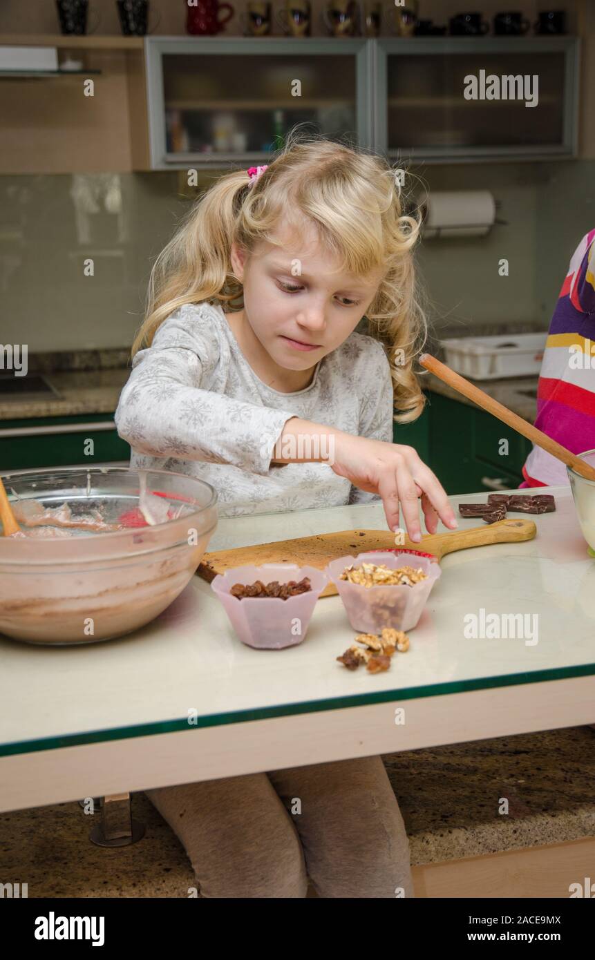 little blond girl preparing sweet muffins Stock Photo - Alamy