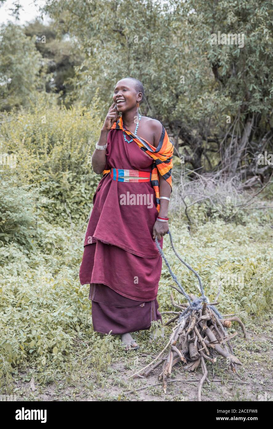 same, Tanzania, 11th June 2019: maasai woman on a mobile phone while ...