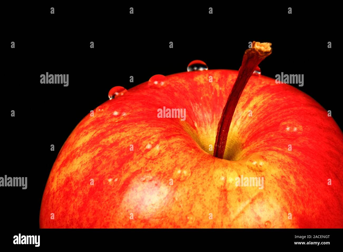 Red eating apple isolated on a black background with water drops Stock ...