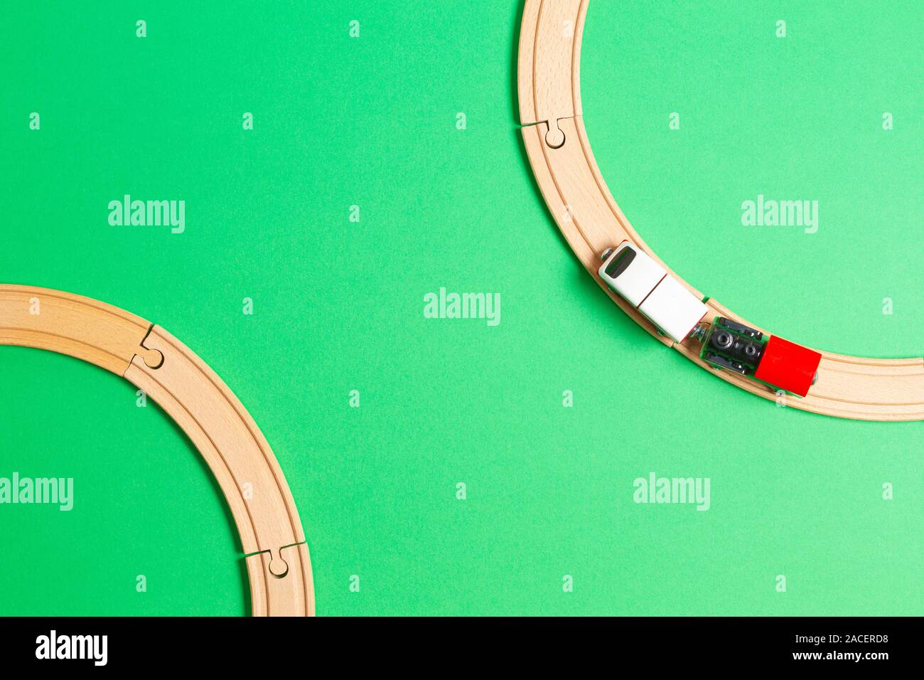 Little toy train with wooden railway on light green background. Top ...