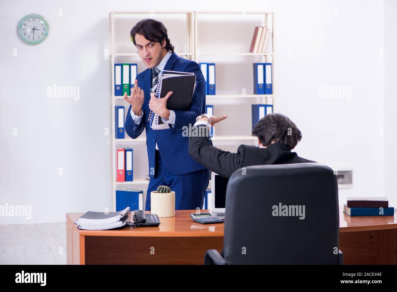 The boss and his male assistant working in the office Stock Photo - Alamy