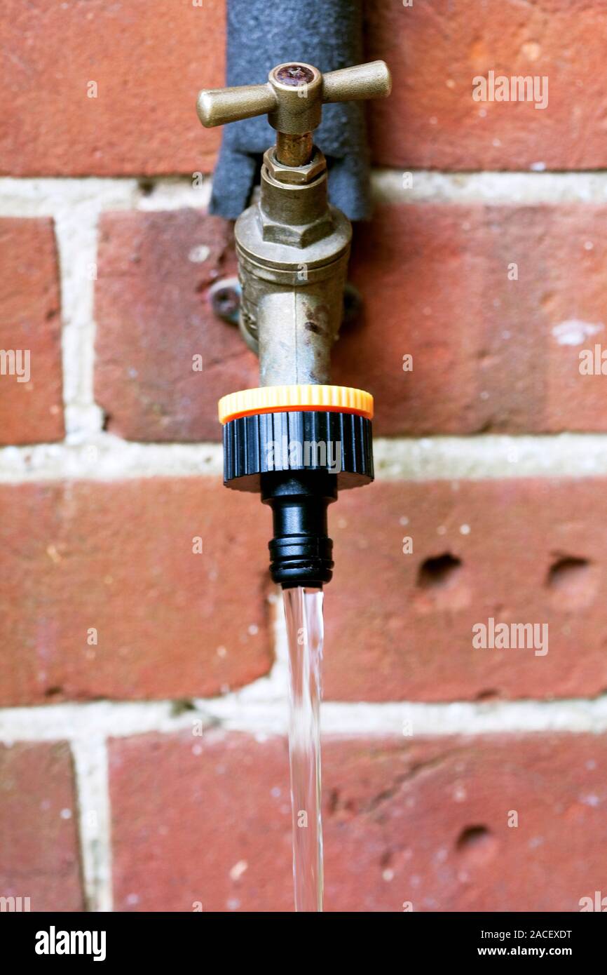 Outdoor tap with a hose connector left running. Failing to completely ...