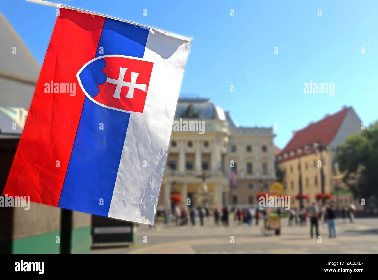 National flag of Slovakia and view of Slovak National Theatre on ...