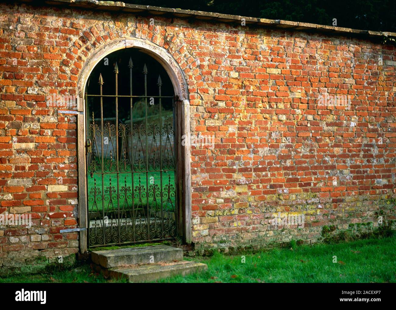 Garden gate. Entrance to a garden in a brick wall. Photographed in ...