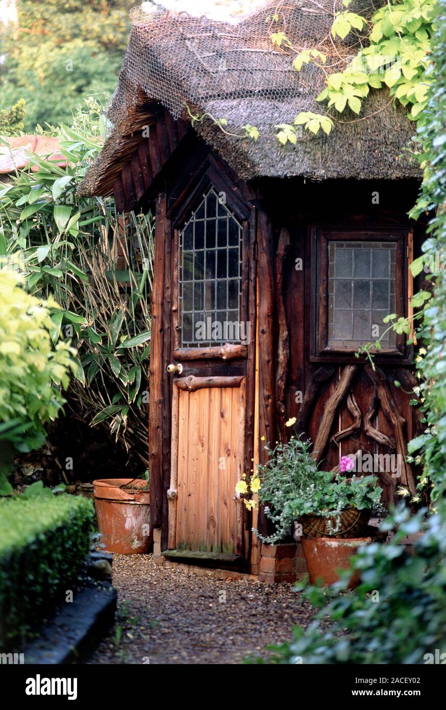 Thatched summer house. Rustic Victorian summer house with leaded ...