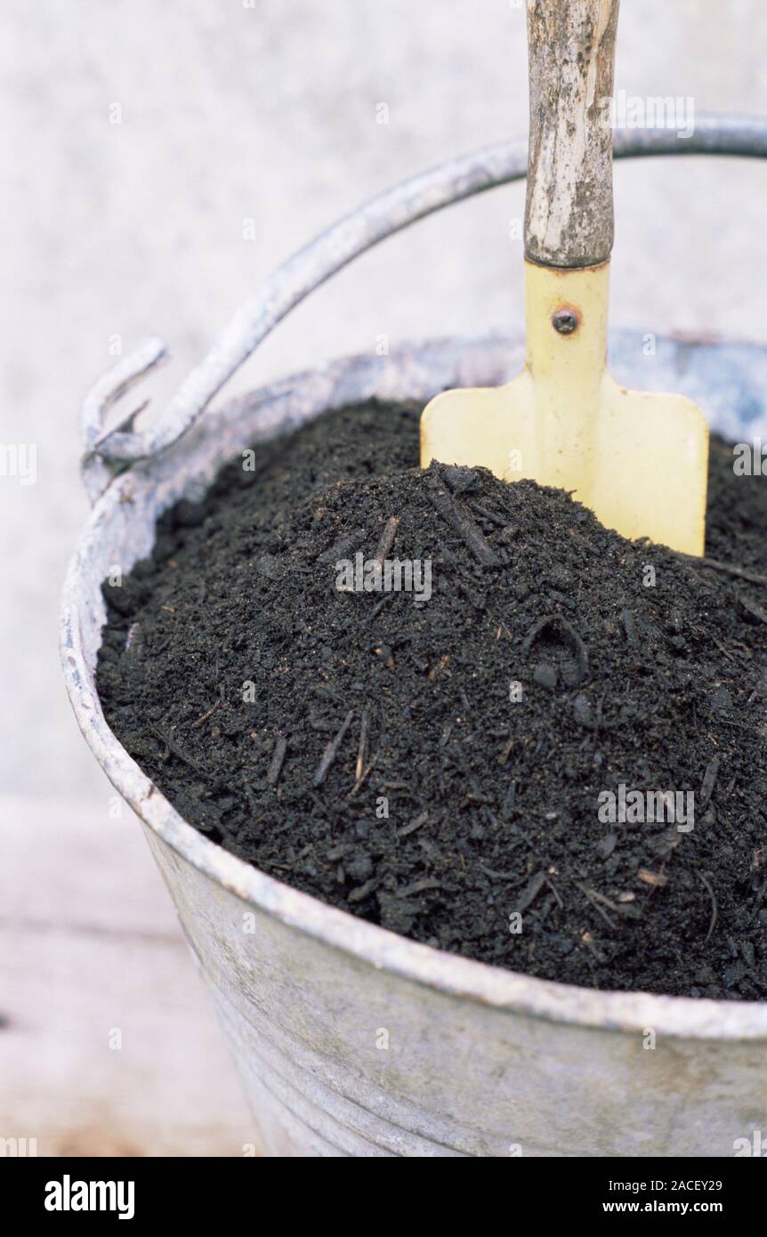 Compost in a bucket with a trowel Stock Photo - Alamy