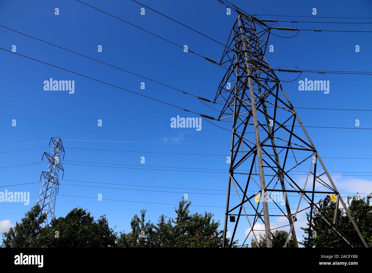 Electricity pylons daytime Stock Photo - Alamy