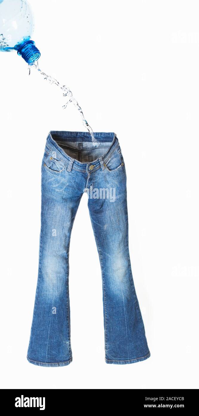 Water footprint, conceptual image. Water flowing into a pair of jeans ...