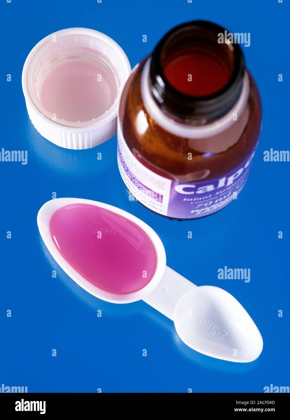 Children's medicine. Bottle and measuring spoon of medicine designed ...