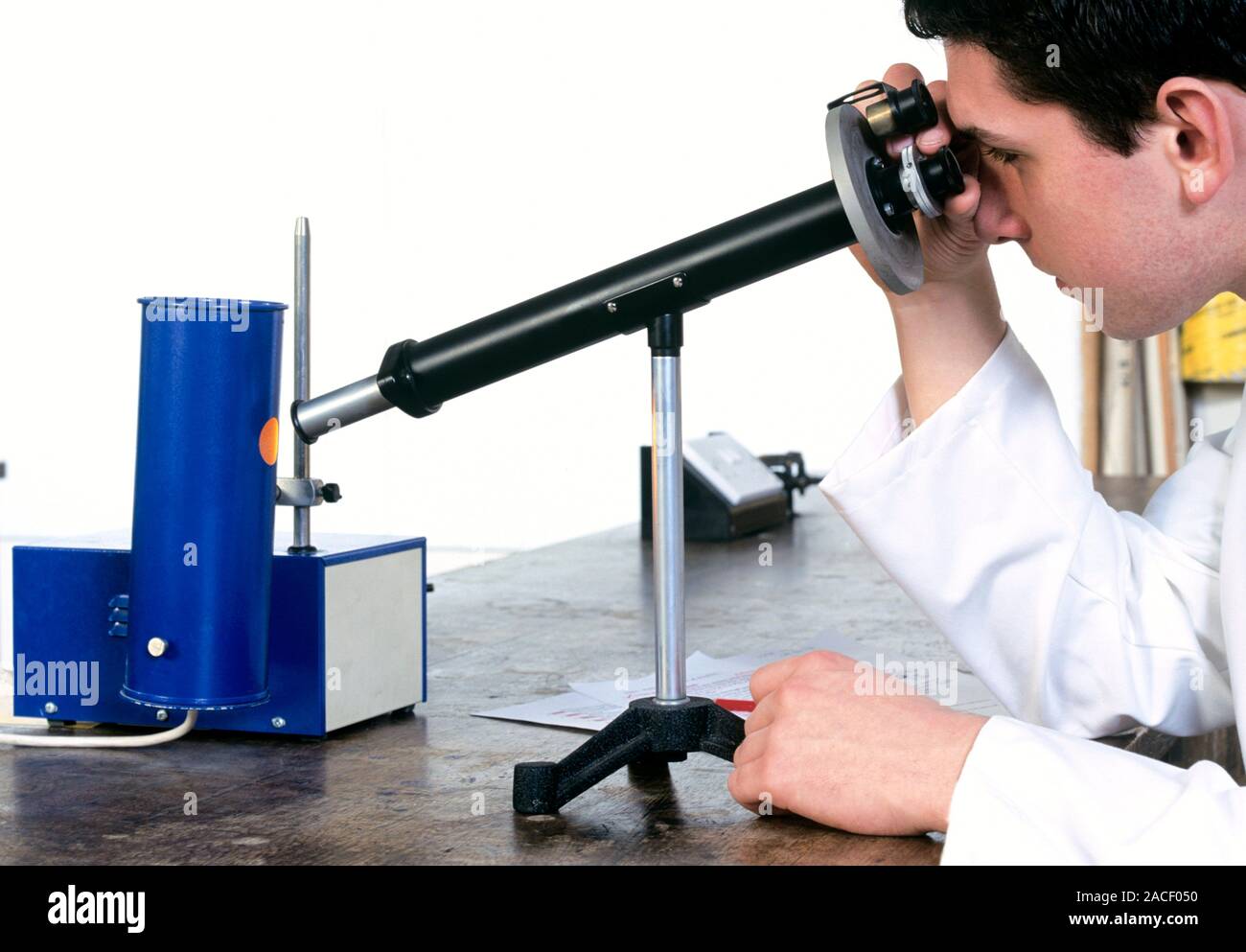 Student looking through a chemical polarimeter. Polarimetry is the ...