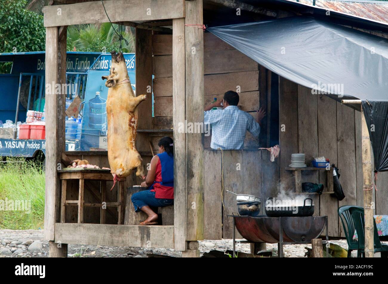 South American street food. Smoked pig hanging at the front of a street ...