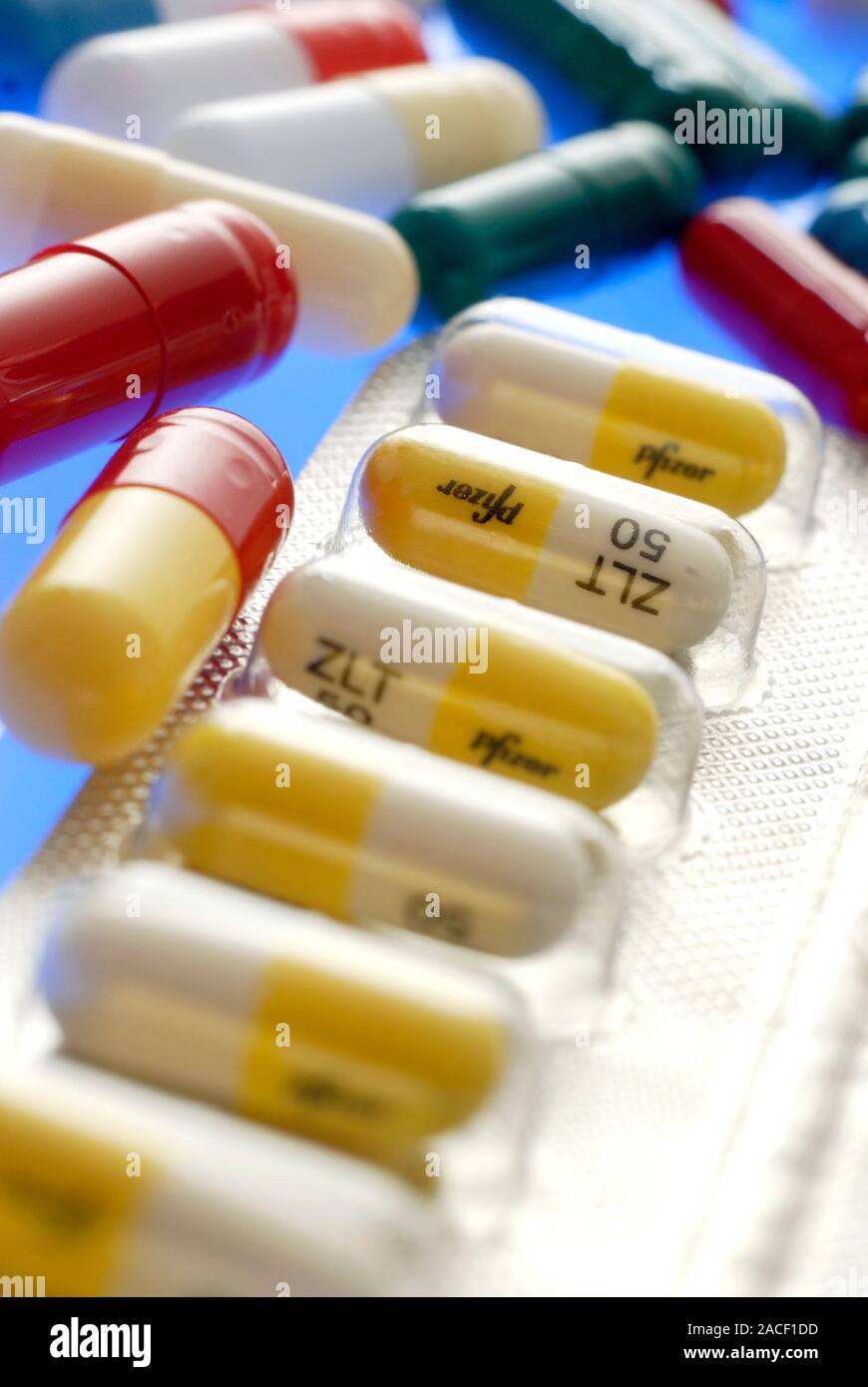 Colourful assortment of pills. Some are in a blister pack (foreground ...