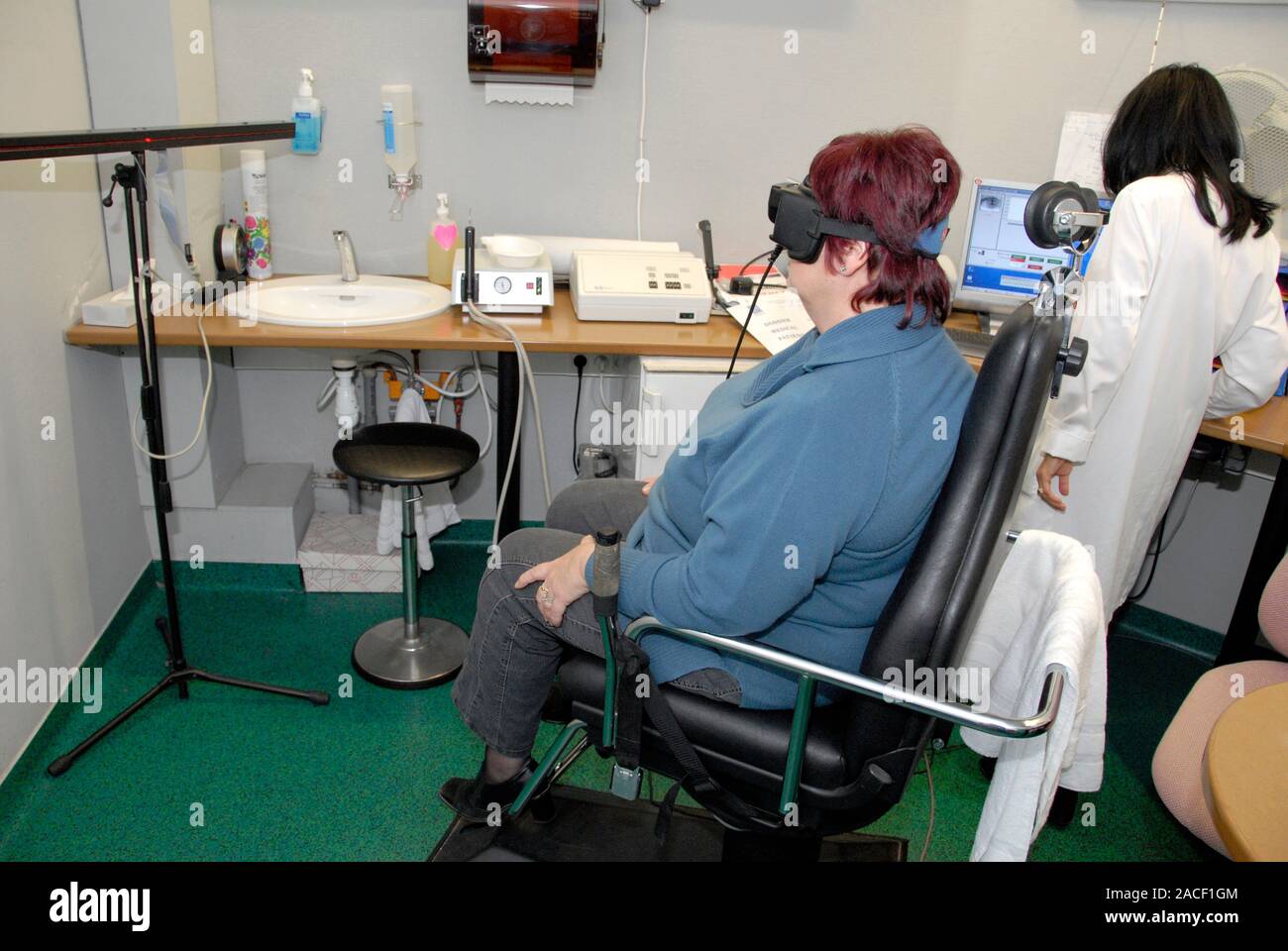 Vertigo test. Patient undergoing a vertigo test. The test is designed ...
