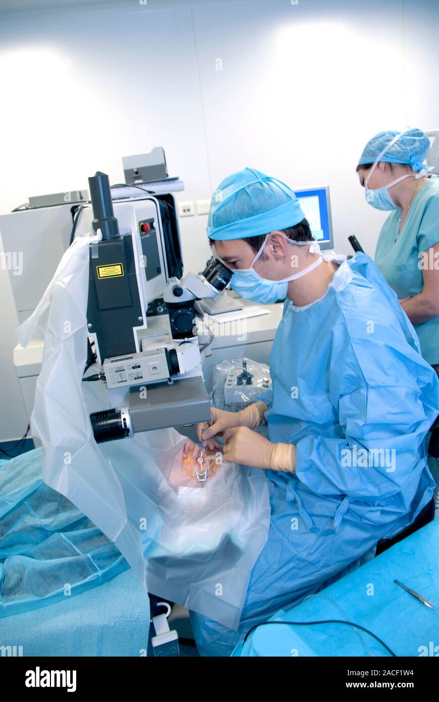 Laser eye surgery. Surgeon carrying out excimer laser refractive ...