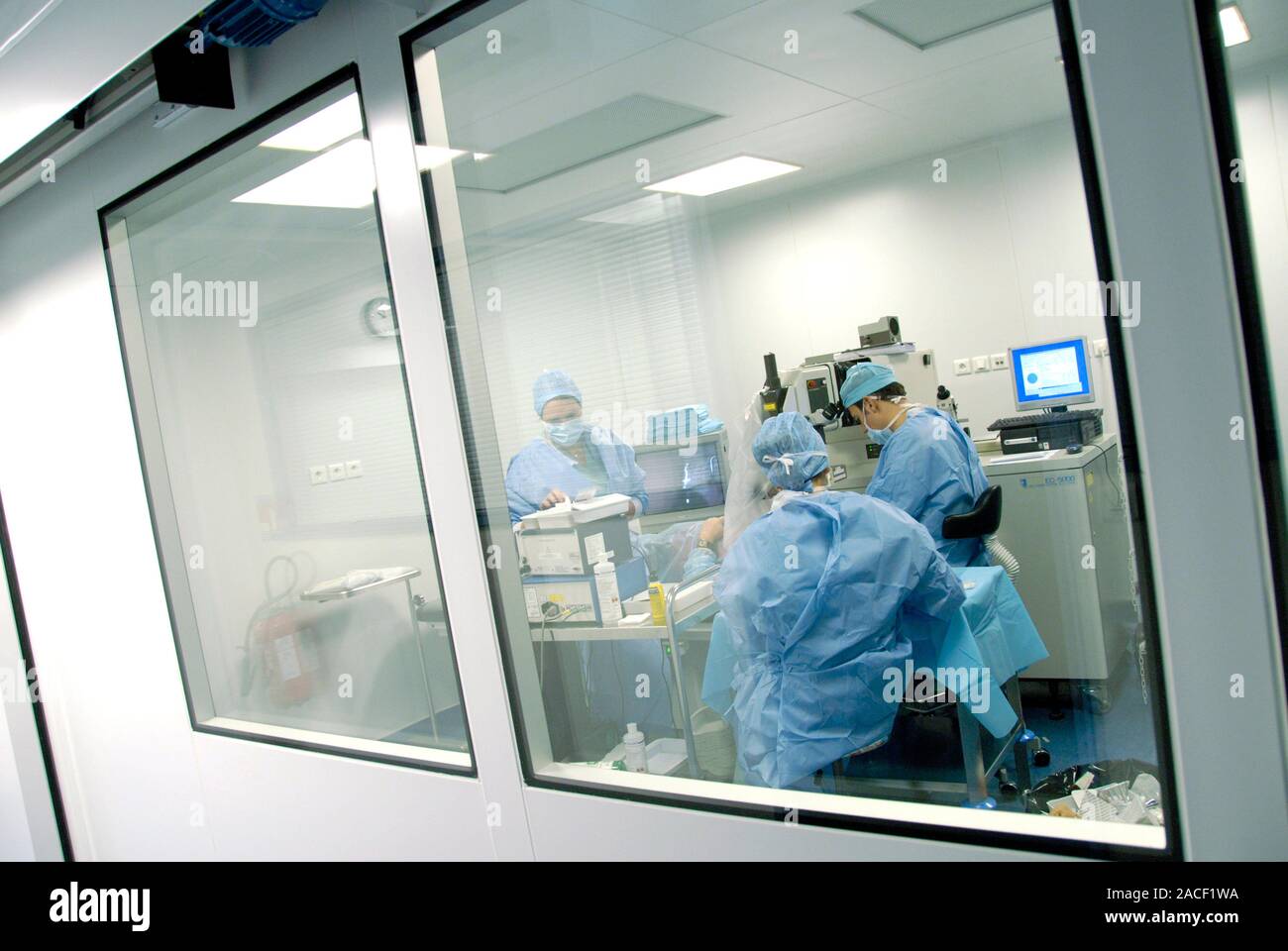 Laser eye surgery. Surgeons carrying out excimer laser refractive ...