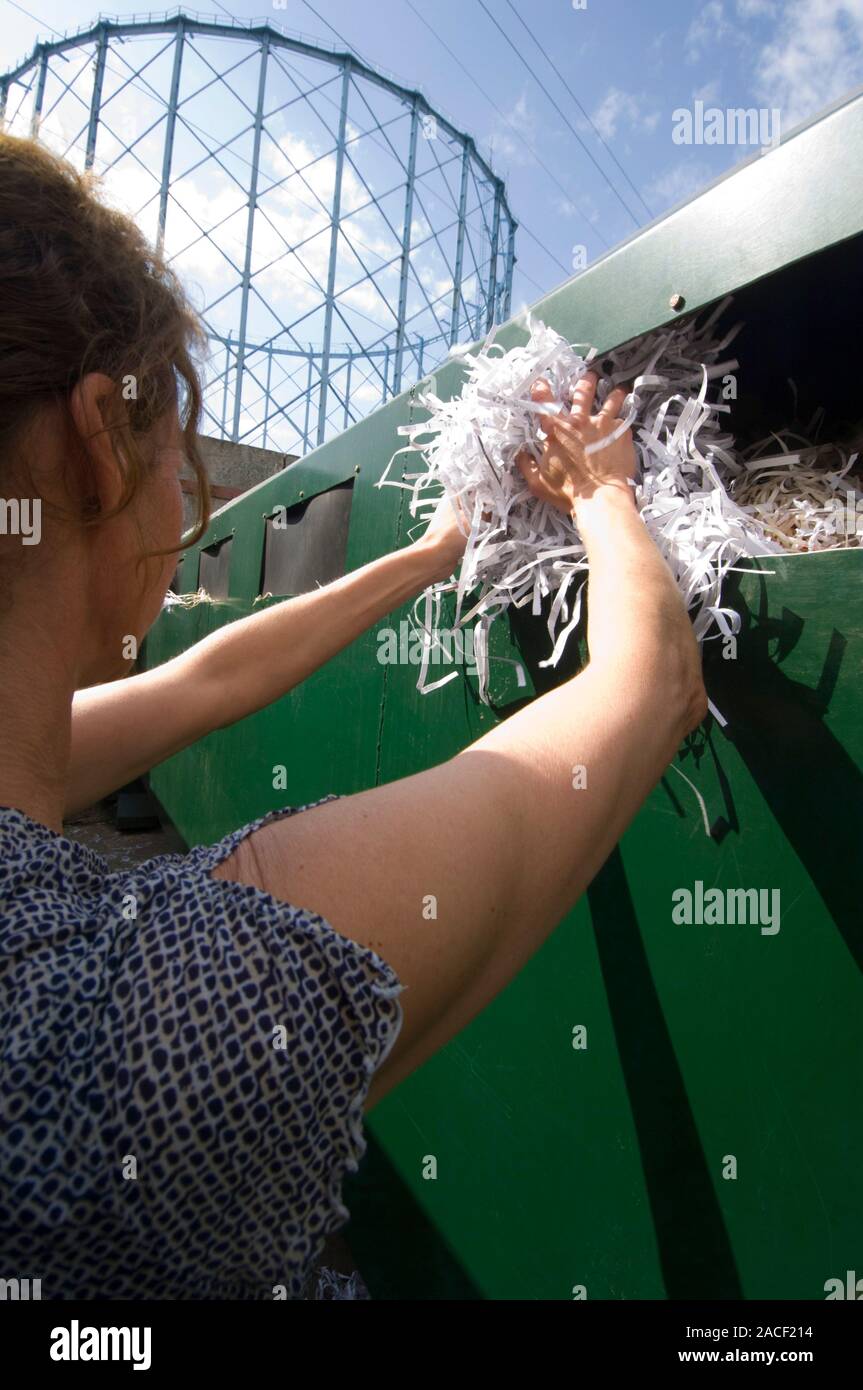 Woman recycling paper at a recycling centre, UK Stock Photo - Alamy