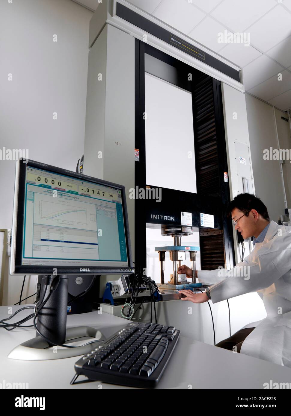 Materials testing. Technician testing an object in a typical static ...