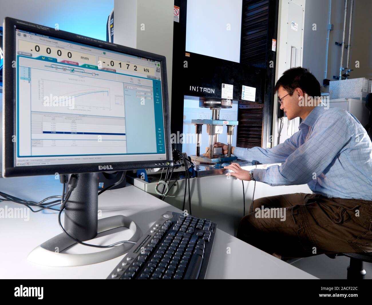 Materials testing. Technician testing an object in a typical static ...