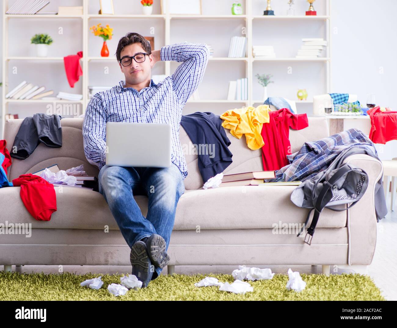 The young man working studying in messy room Stock Photo - Alamy