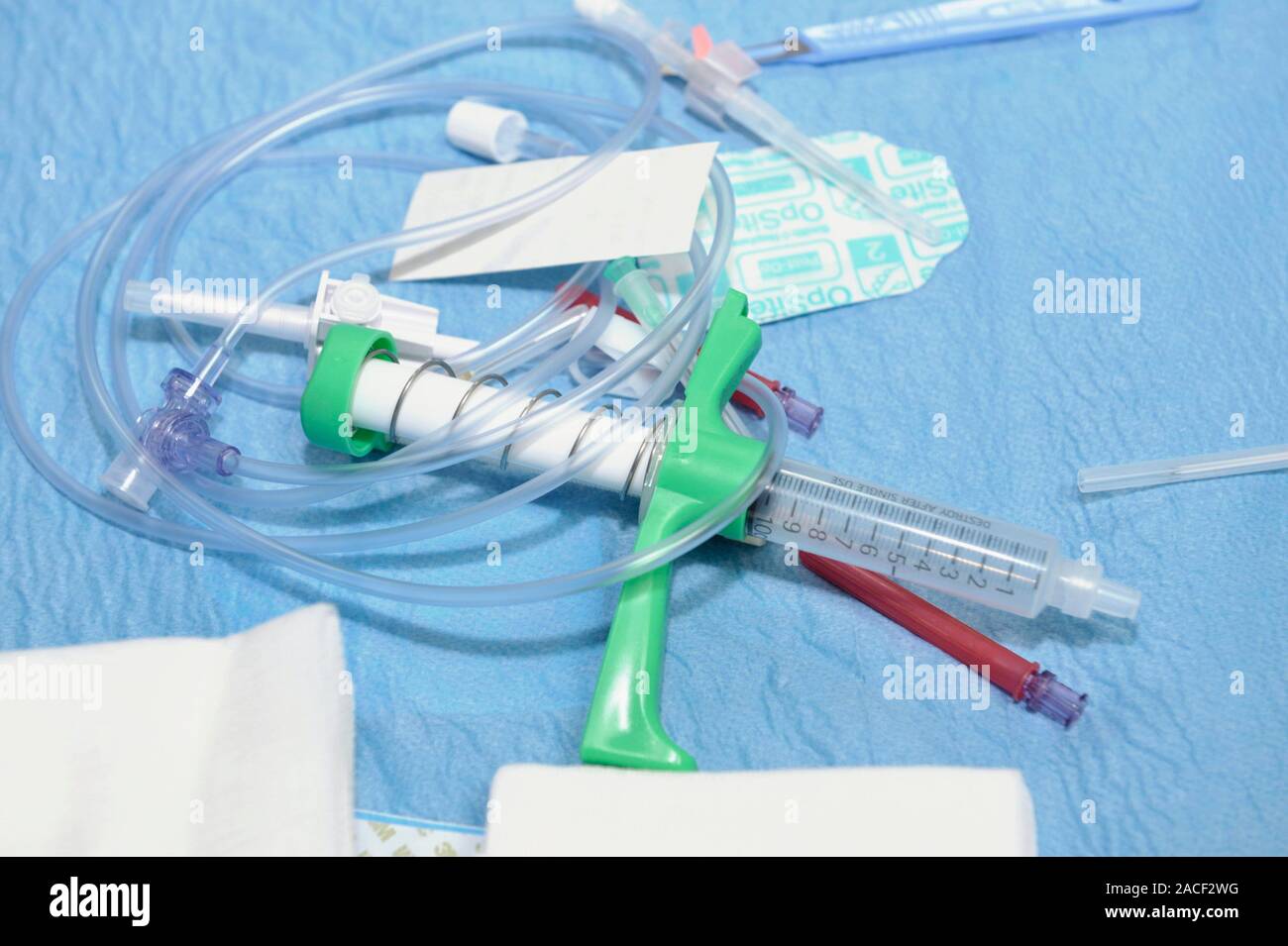 Tumescent anaesthesia equipment. Close-up of a syringe (centre) and ...