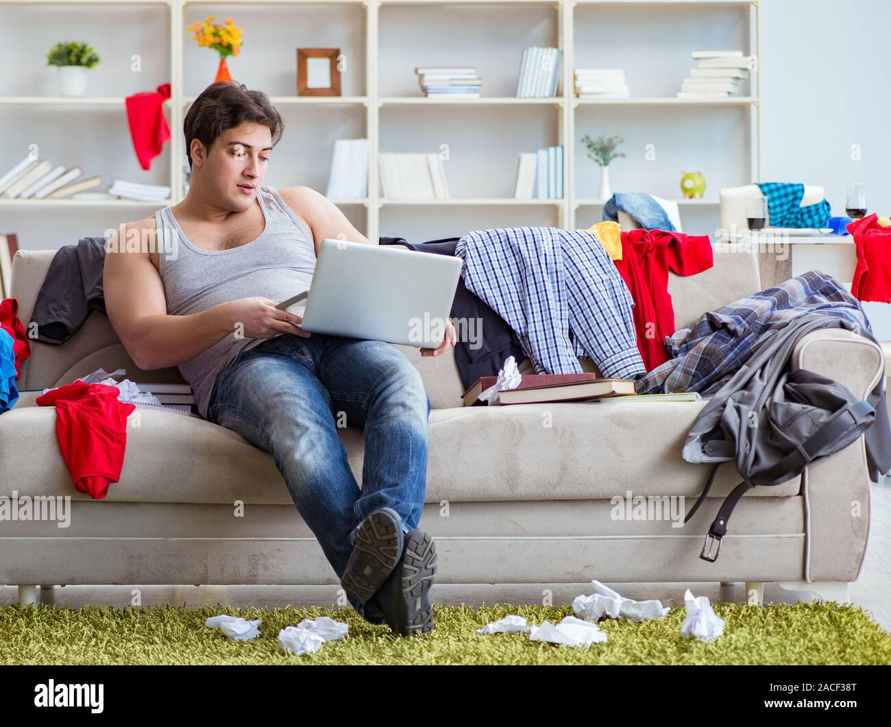 The young man working studying in messy room Stock Photo - Alamy