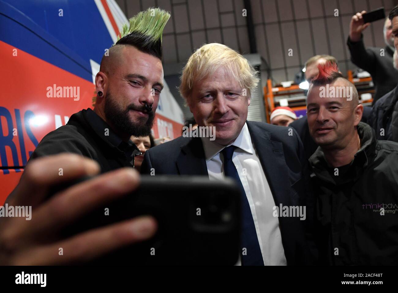 Prime Minister Boris Johnson poses for photos with members during a ...