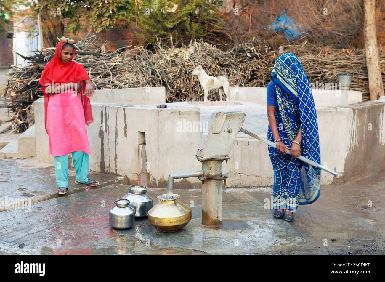 Water well. Women collecting drinking water from a well. Photographed ...