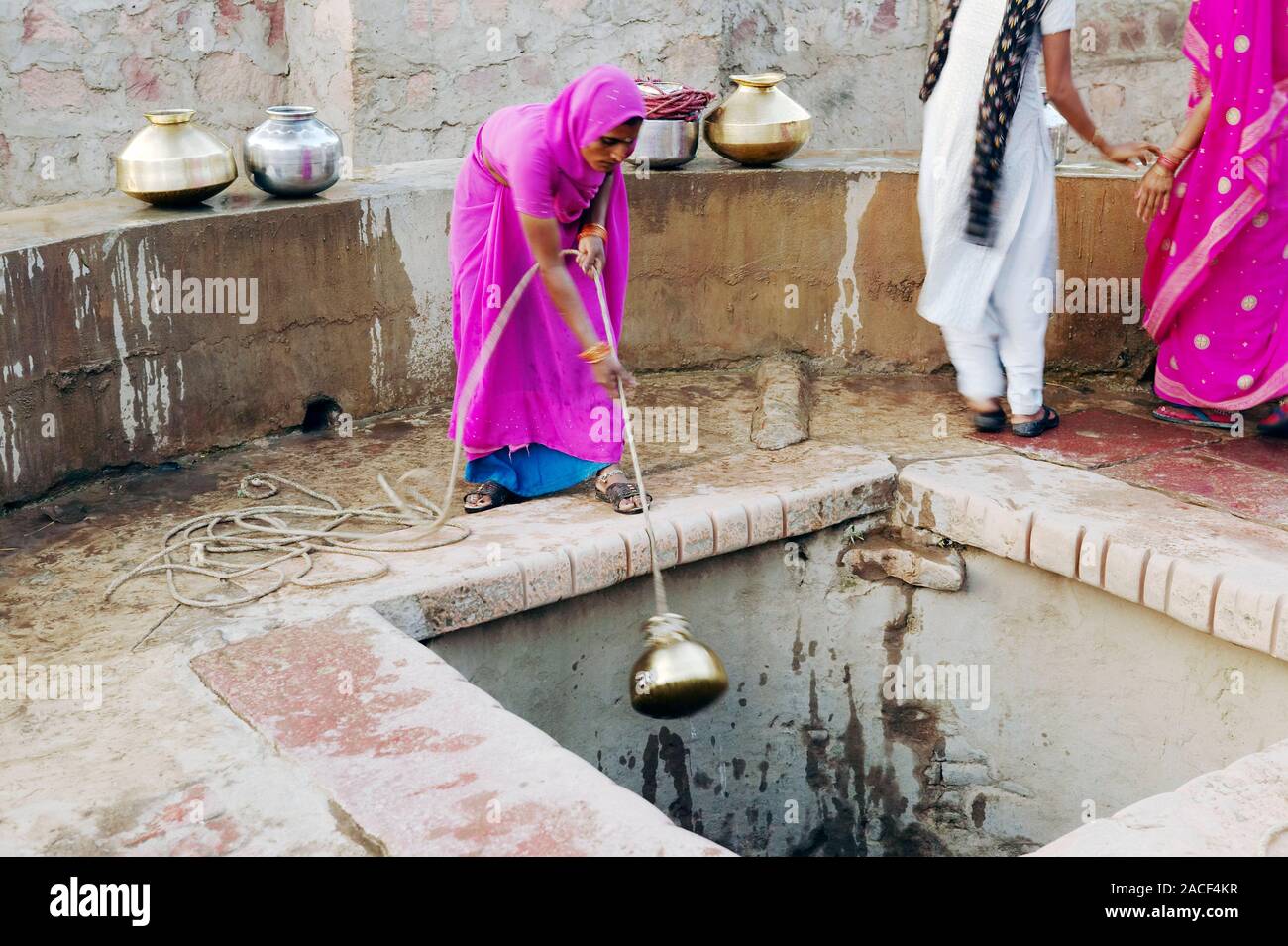 Water well. Women collecting drinking water from a well. Photographed ...