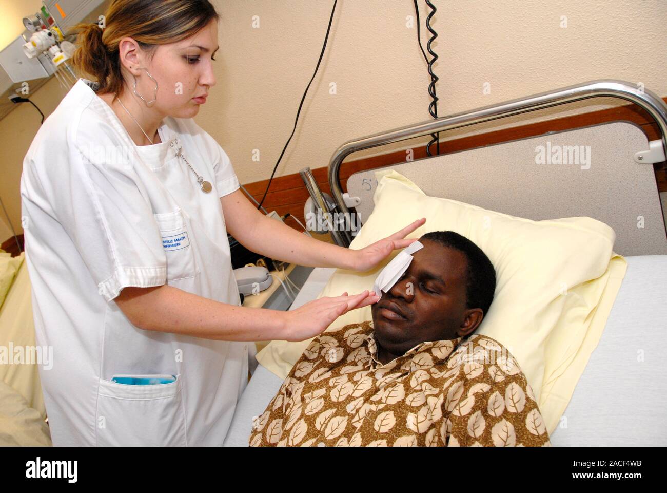 Nurse changing a facial dressing. Hospital nurse changing a patient's ...