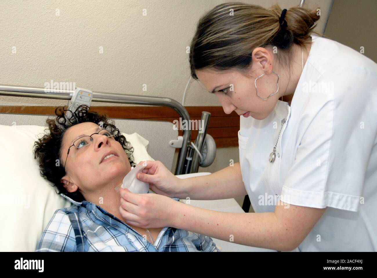 Nurse changing throat dressing. Hospital nurse applying a new dressing ...