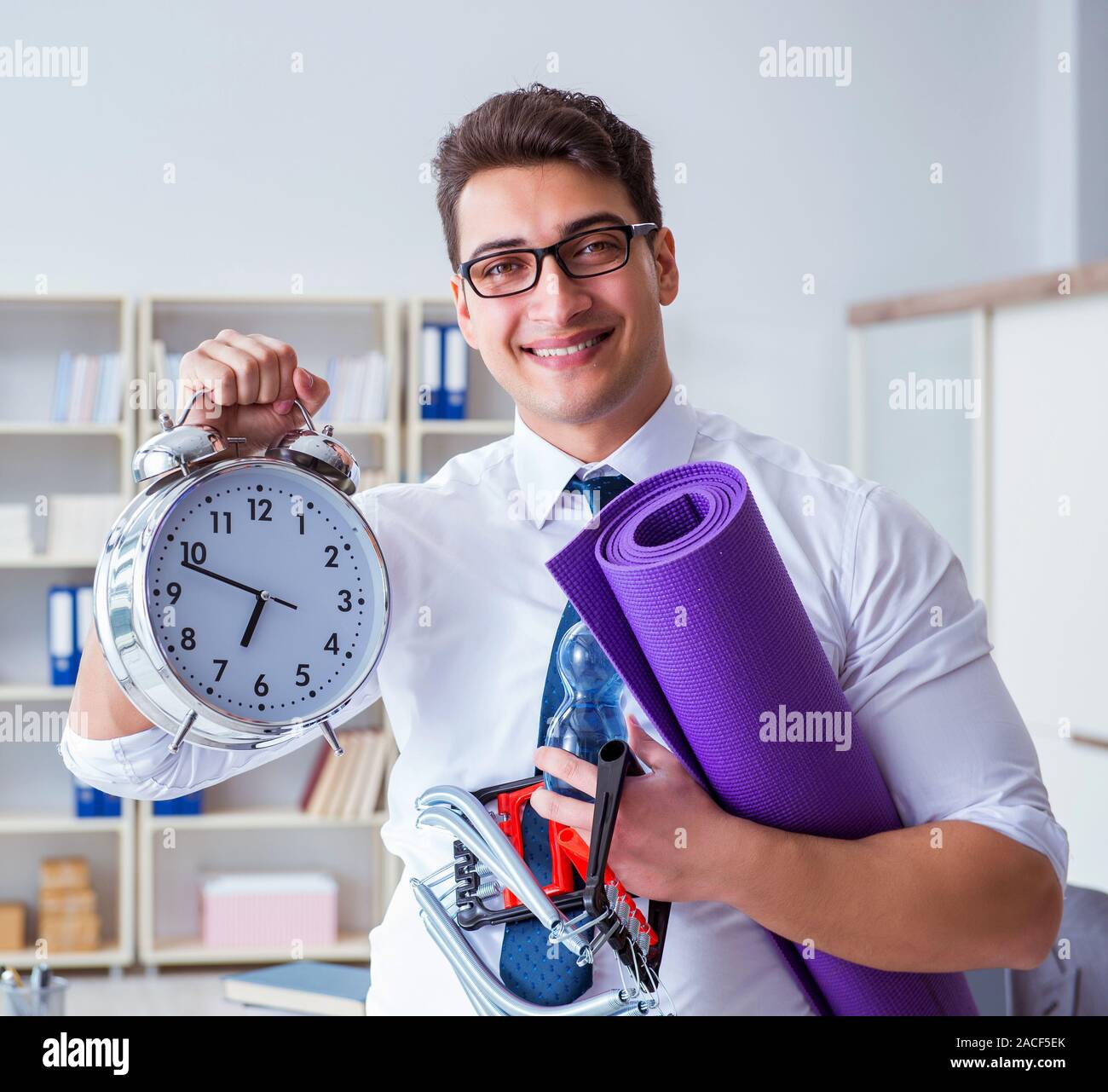The businessman rushing to sports with clock Stock Photo - Alamy