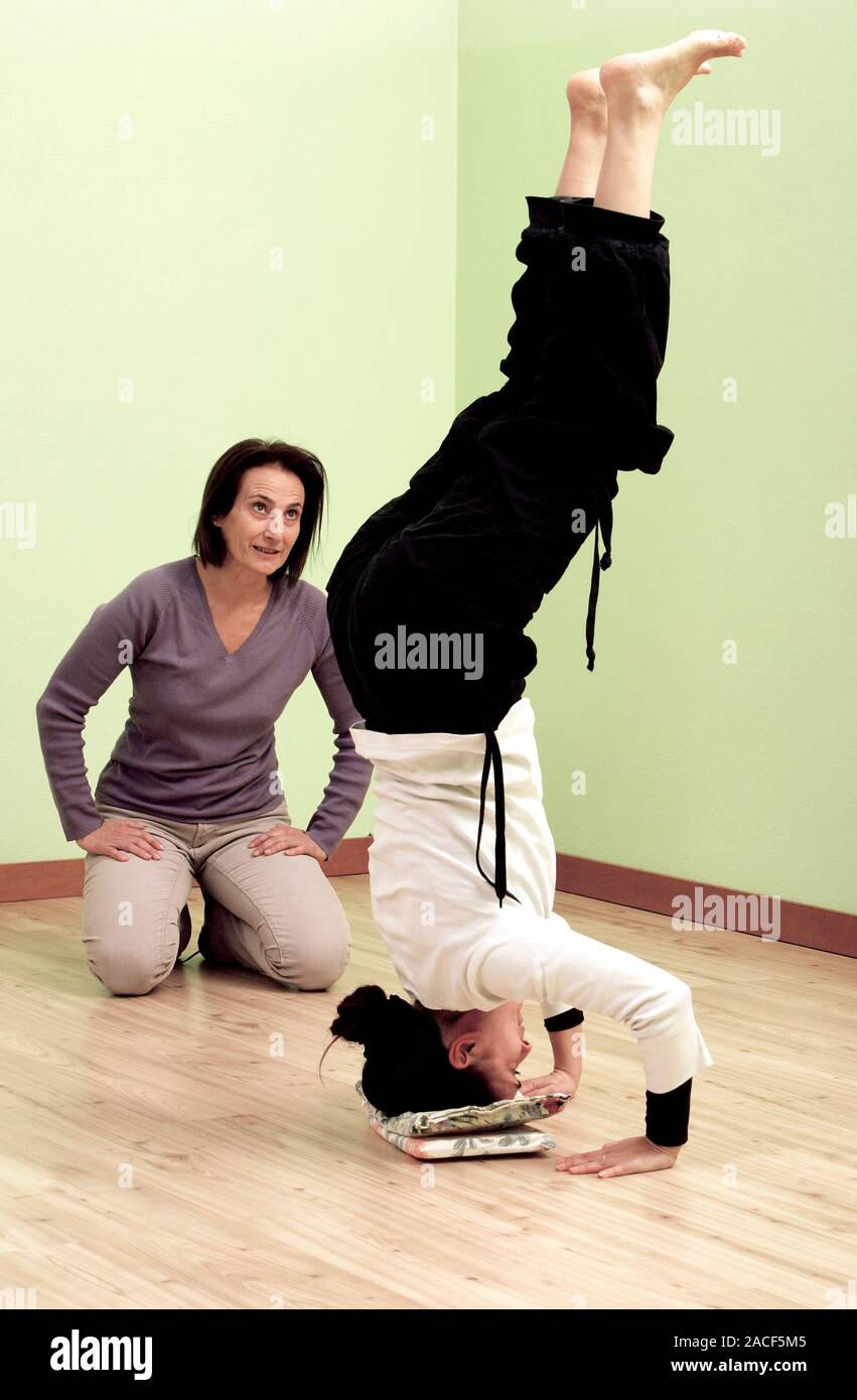 Feldenkrais method. Woman being taught the Feldenkrais method. The ...