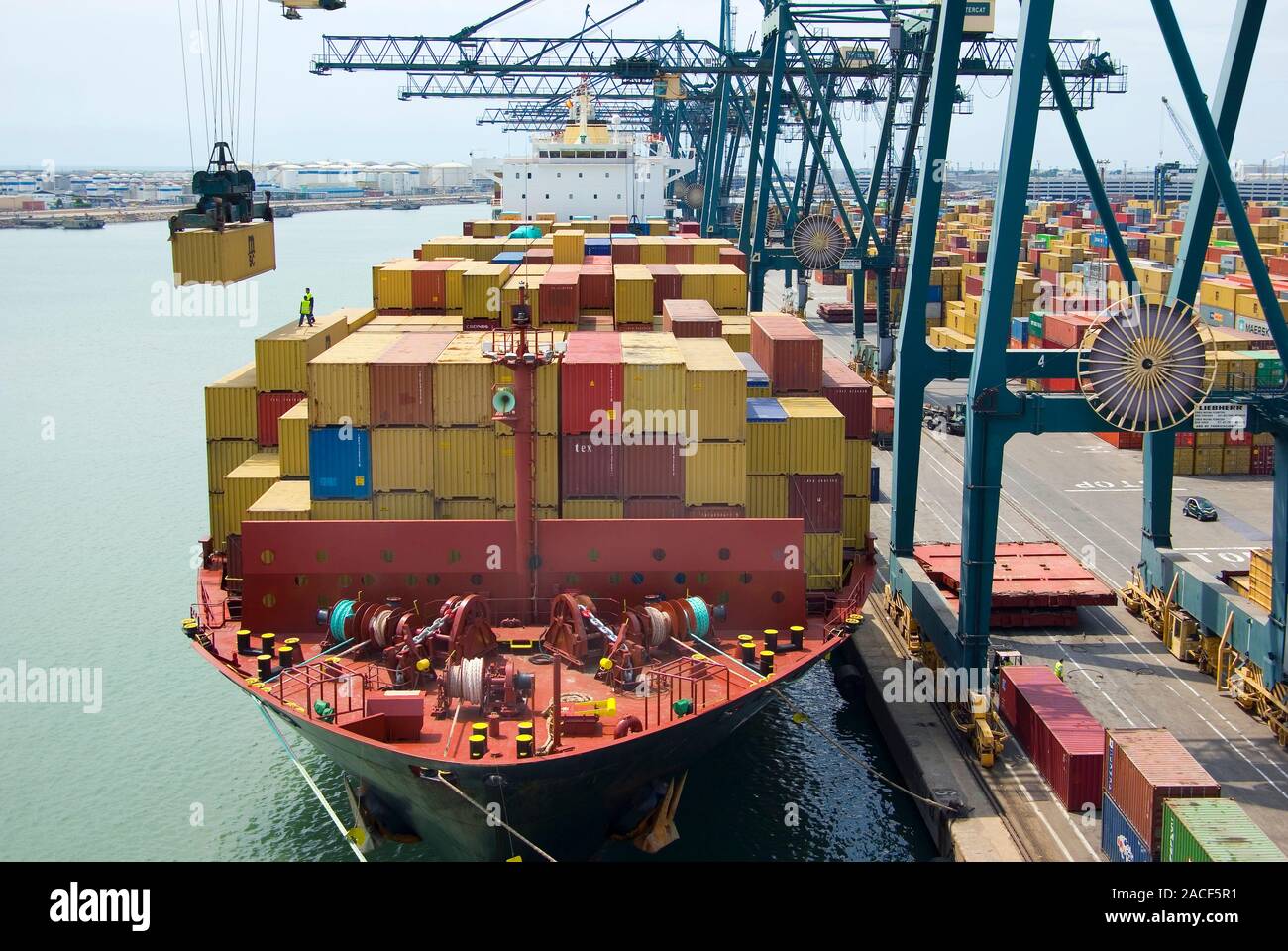 Container ship and port. The containers are the large rectangular boxes ...