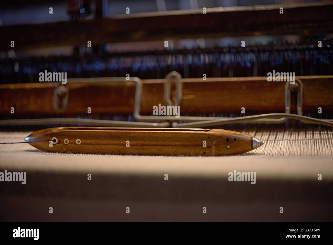Traditional loom with the work started, unfinished woolen fabric with ...