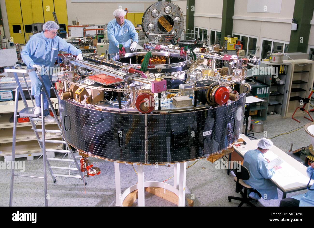 Cluster satellite construction. Engineers assembling and constructing ...