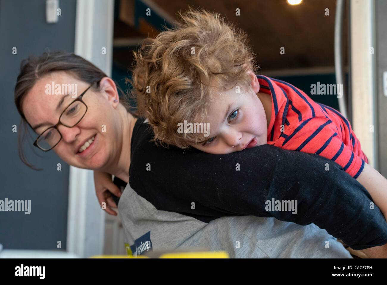 Denver, Colorado - Mariel Hjermstad carries her tired son, Adam ...
