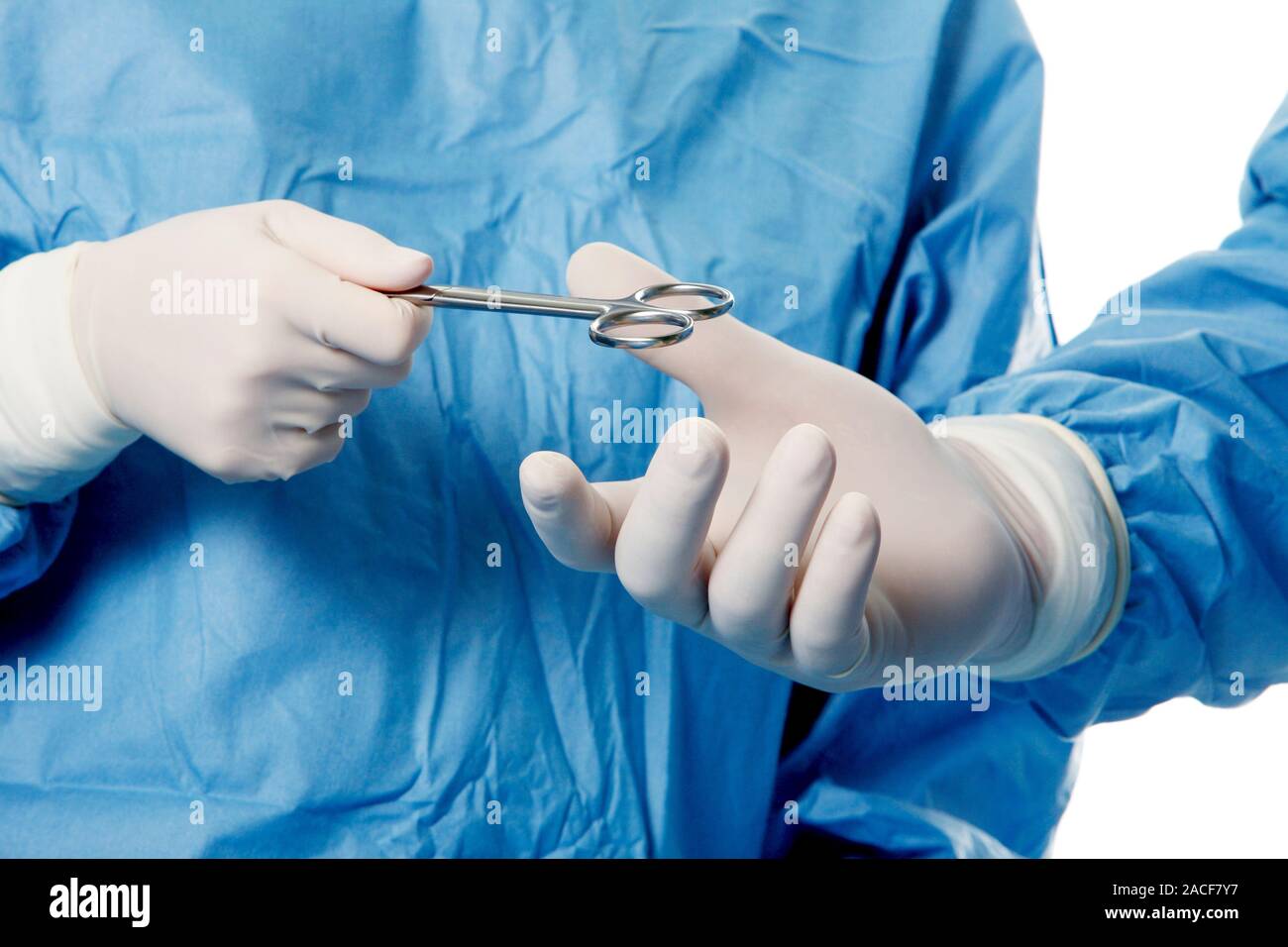 Surgery. Surgical assistant passing forceps to a surgeon during an ...