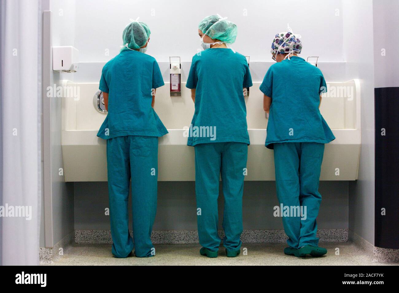 Scrubbing up. Surgeons cleaning their hands before surgery. Cleanliness ...