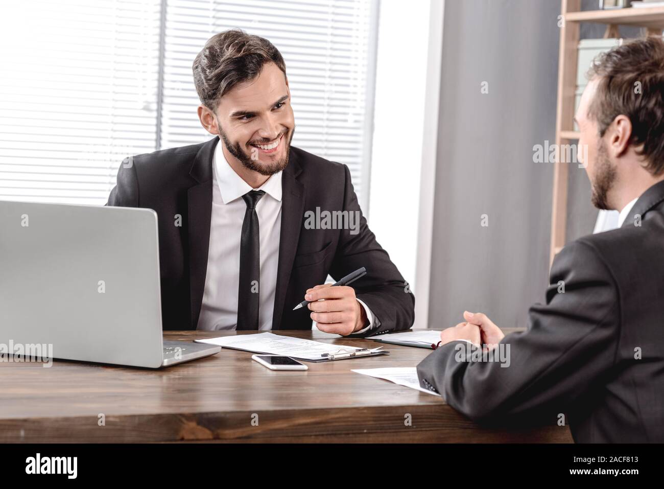 Job Interview. Employer looking at candidate cheerful checking resume ...