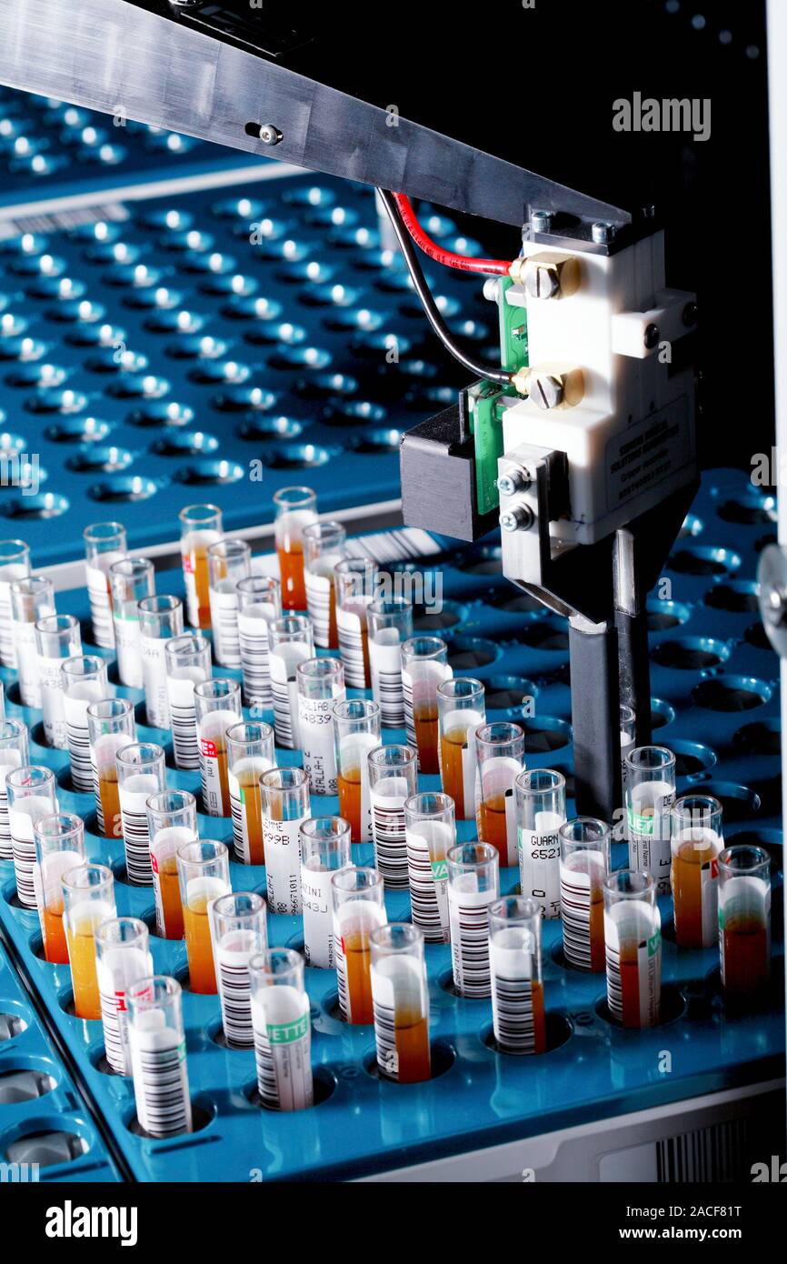 Automated blood sample testing. Machine selecting blood samples from a ...