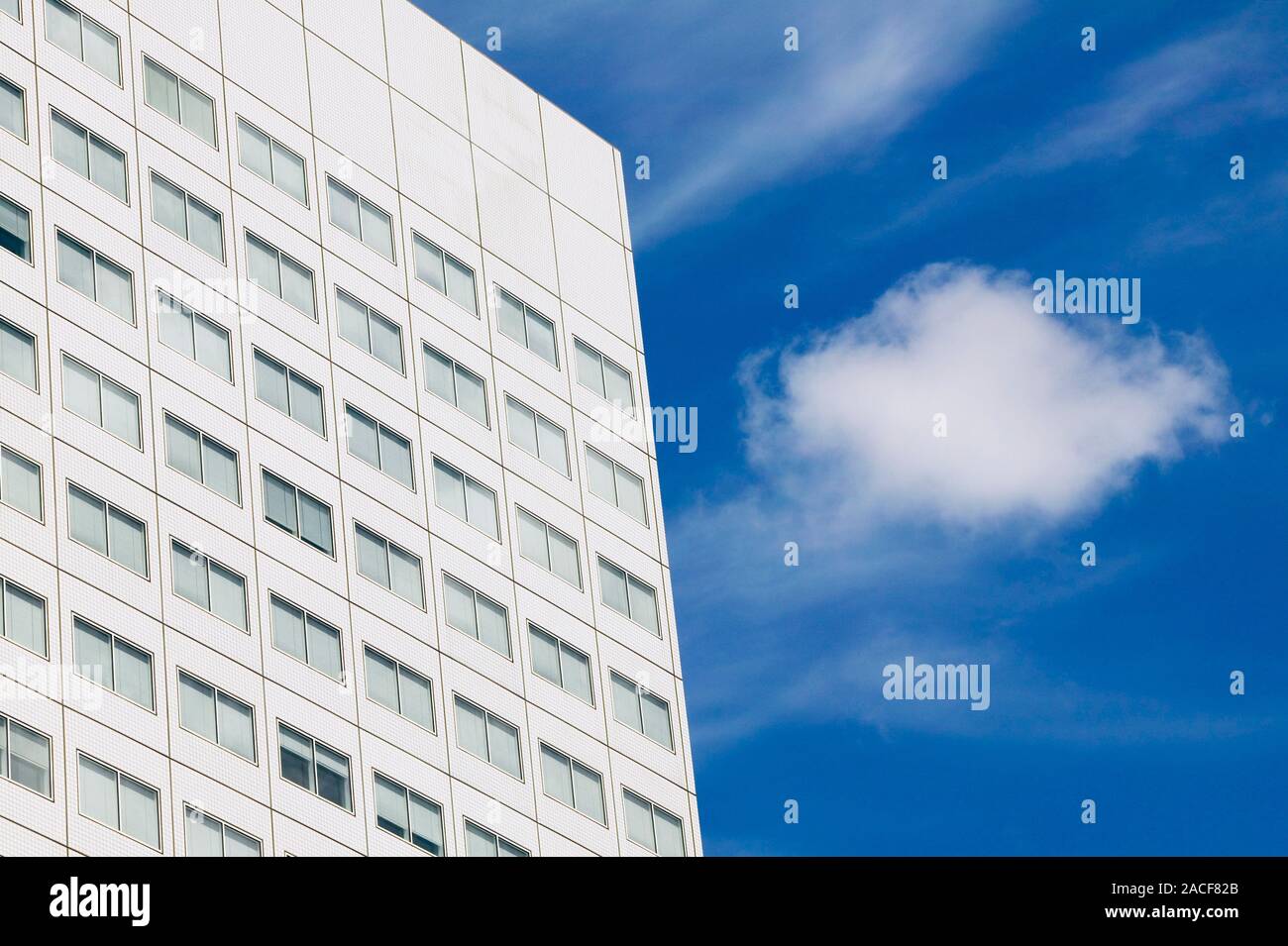 Office block. Windows in a corner of an office block, seen against a ...