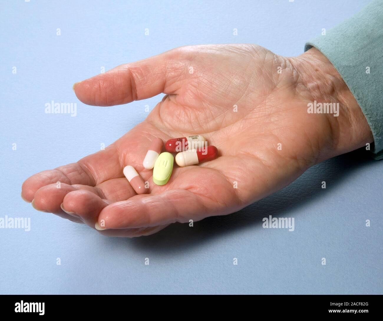 Drug cocktail. Hand holding a combination of drugs that are used to ...