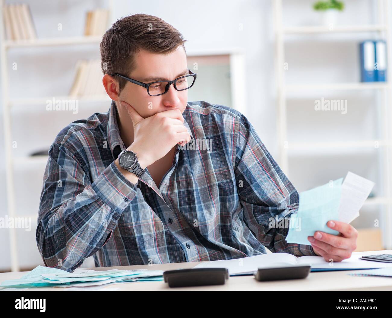 The young man frustrated at his house and tax bills Stock Photo - Alamy