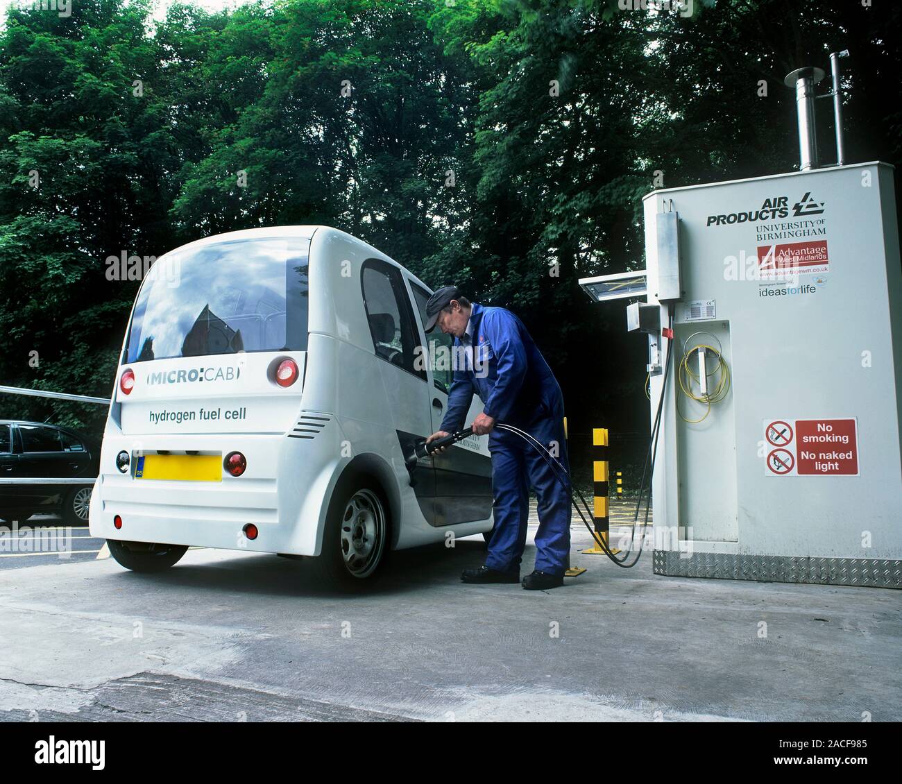 Hydrogen fuel cell car being refuelled at a hydrogen filling station as ...