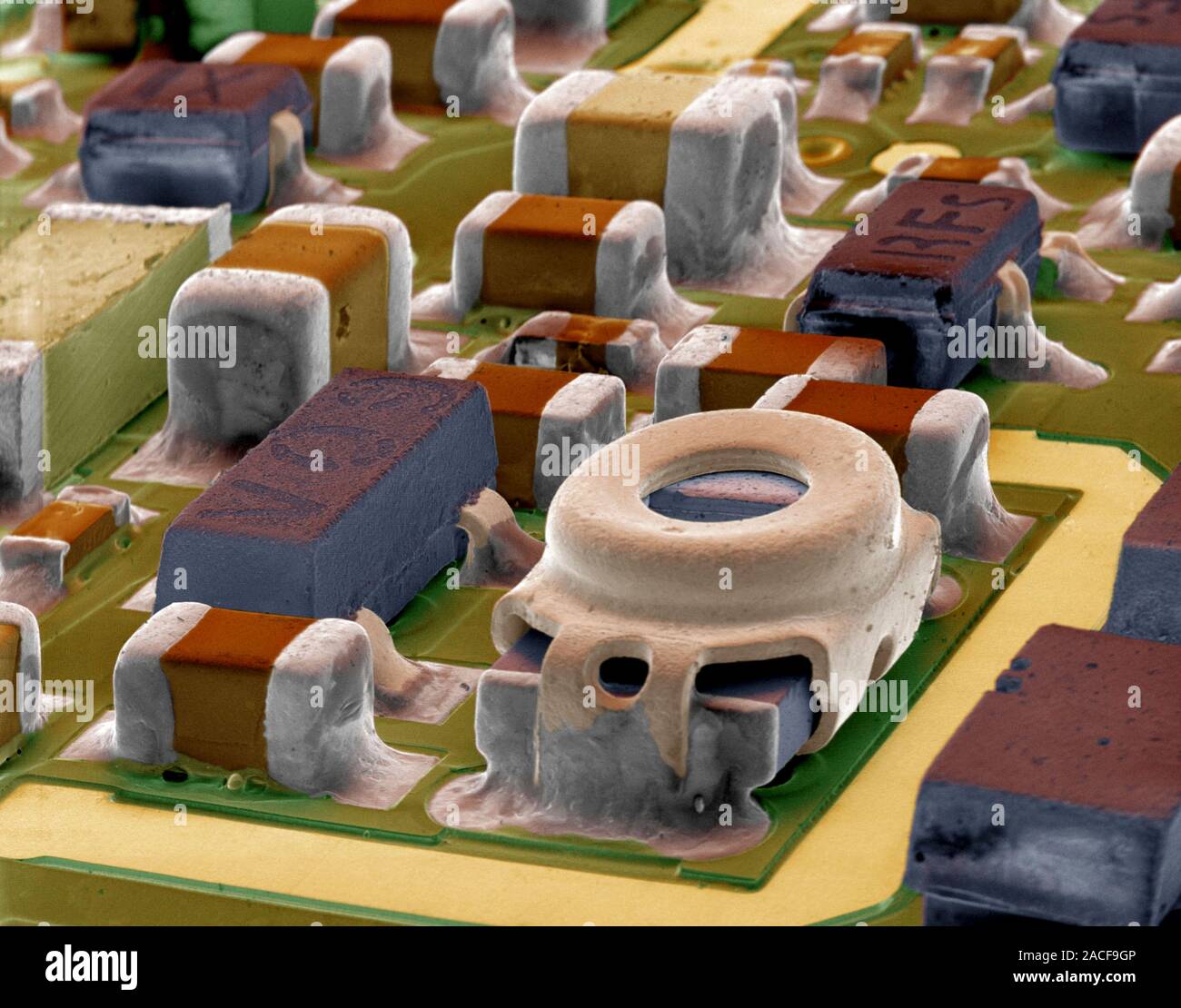 Surface-mount device (SMD), coloured scanning electron micrograph (SEM ...