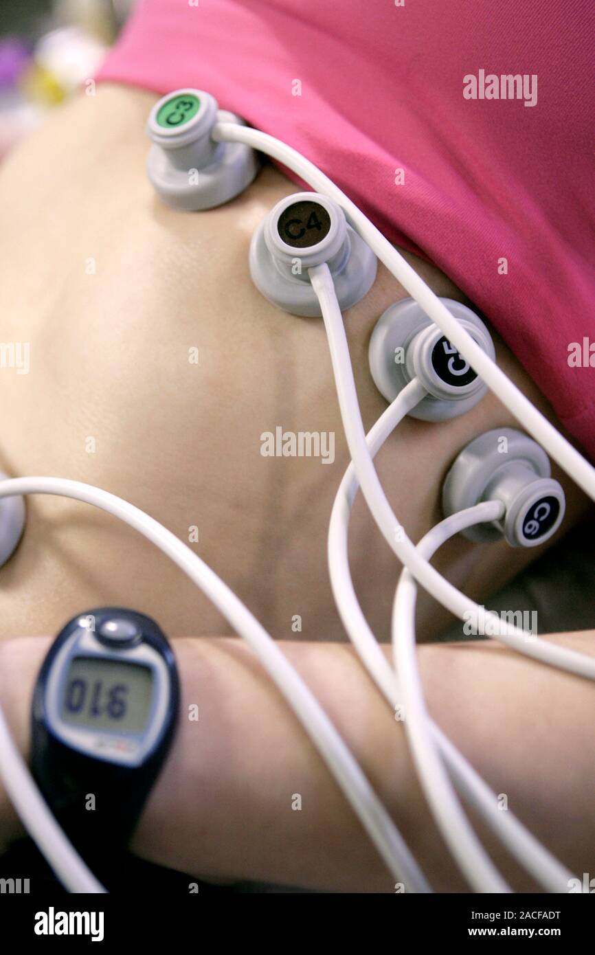 Medical testing. Electrodes stuck to the abdomen of a person undergoing ...